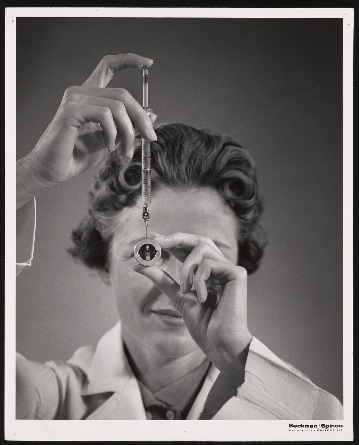 Woman injecting a sample into a Beckman Model E Centrifuge component ...