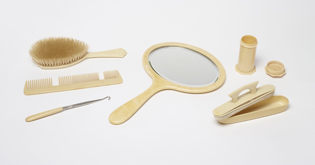 Pyralin mirror, hairbrush, comb, nail buffer, button hook, and trinket ...