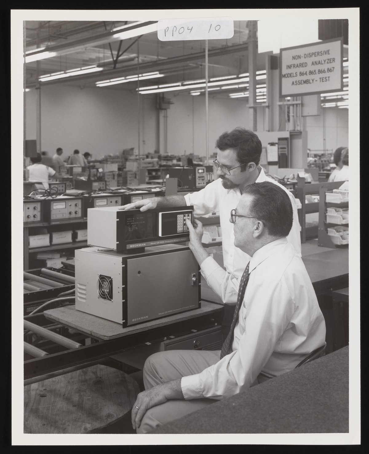 Two men testing a Beckman Model 1000 Combustion Efficiency System ...