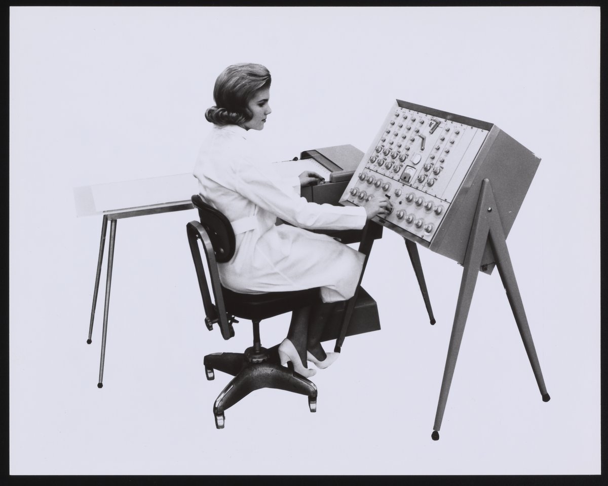 Unidentified woman using a Beckman Model TC Electroencephalograph ...