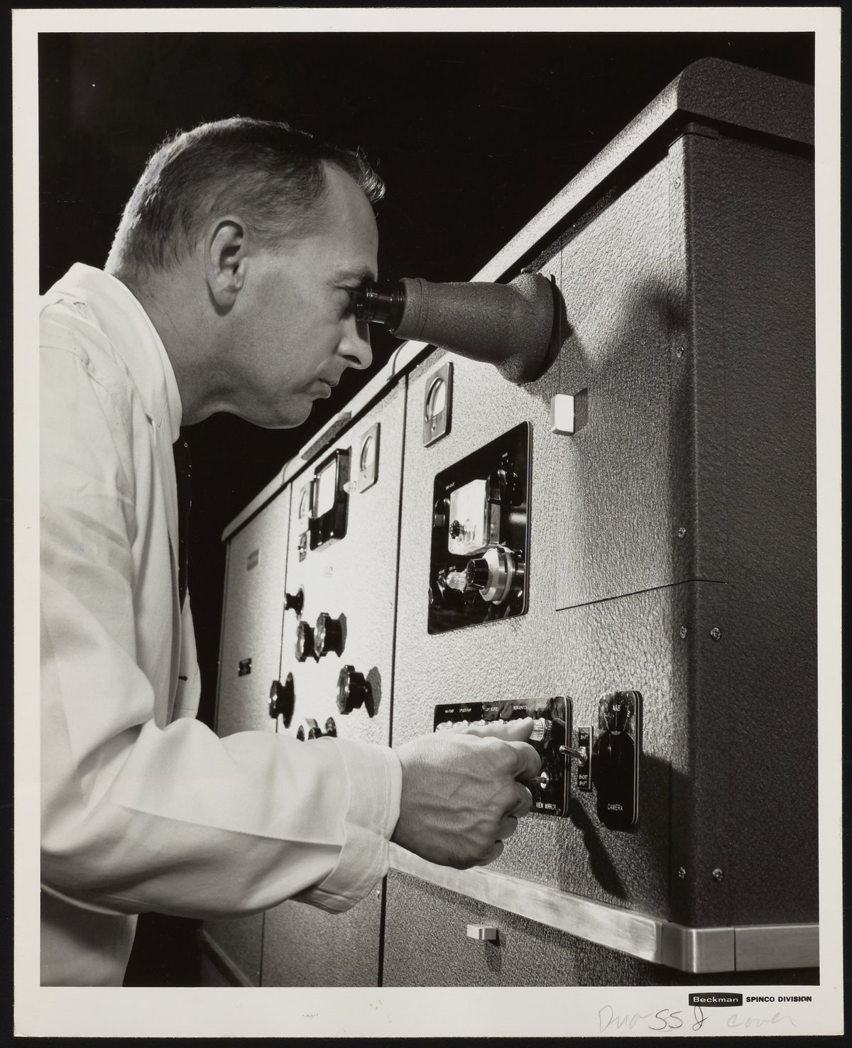 Man looking into eyepiece of a Beckman Model E Centrifuge - Science ...