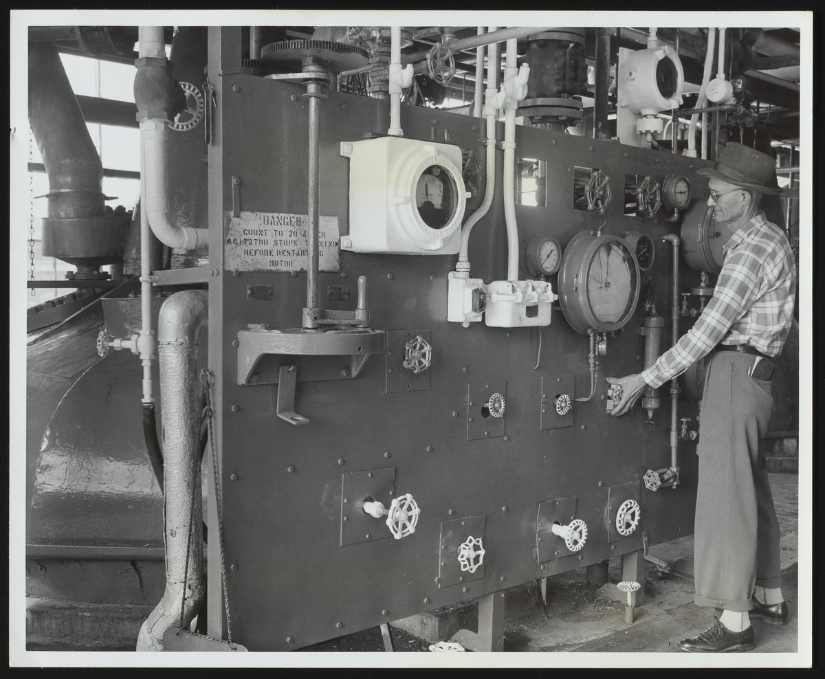 Employee operating autoclave control panel at Hercules Hopewell plant ...